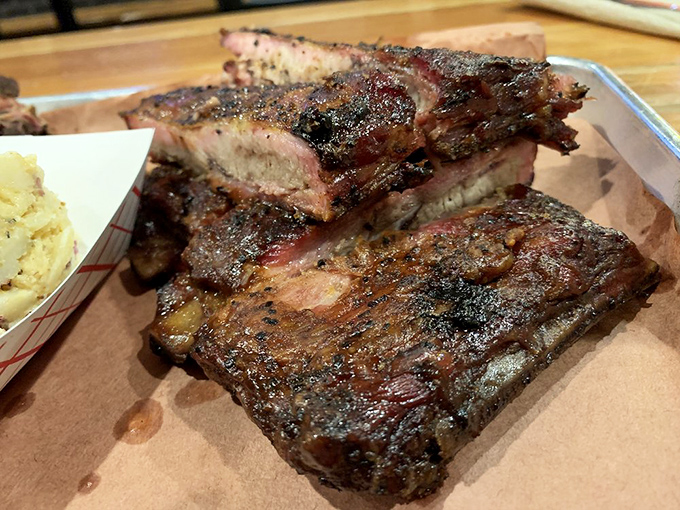 These ribs showcase that coveted pink smoke ring - the holy grail of barbecue perfection right there.