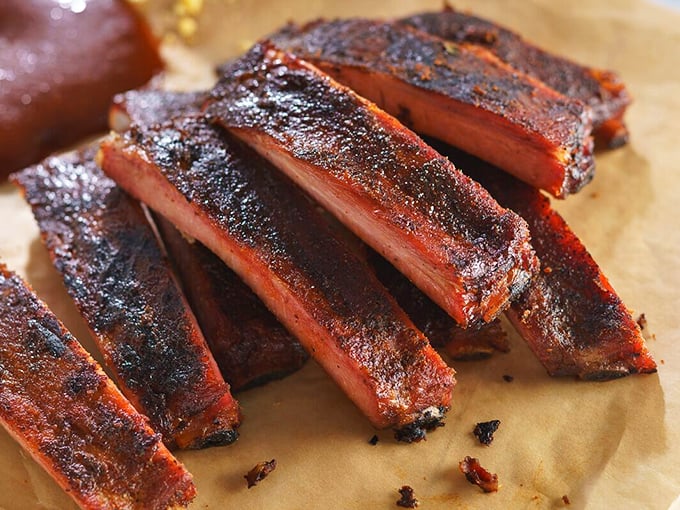 These ribs don't just fall off the bone&mdash;they practically leap into your mouth, their smoke ring a badge of honor earned through hours of patient cooking.