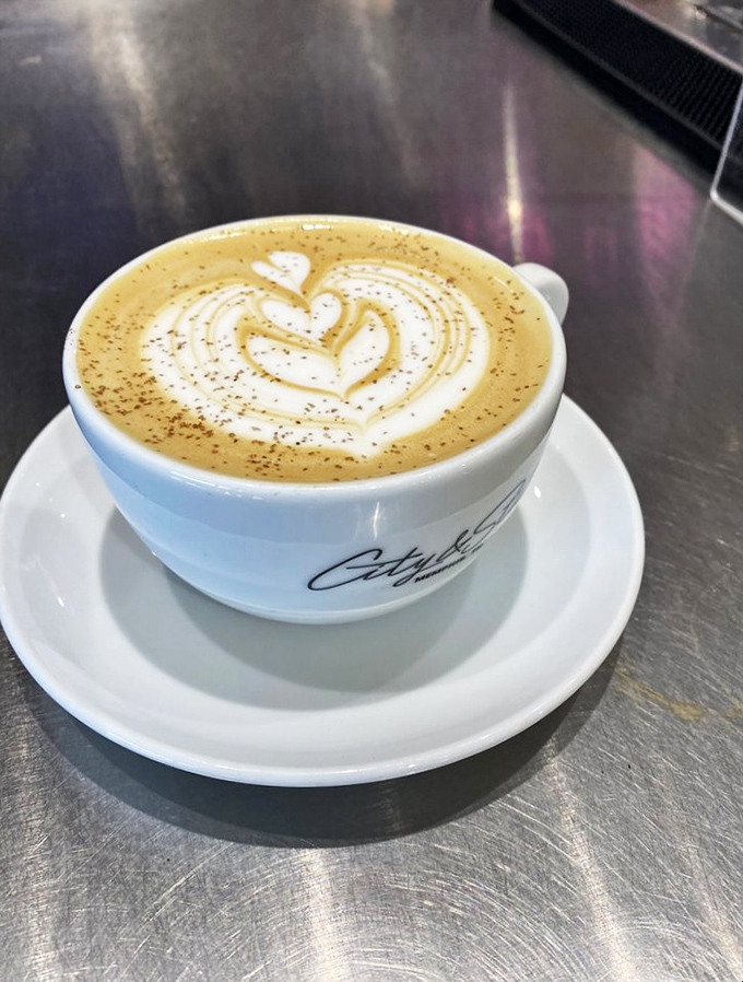 Latte art so beautiful it should hang in a gallery, topped with a dusting of spice that whispers, "This isn't your ordinary coffee experience."