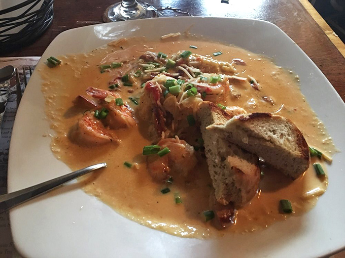 These shrimp and grits aren't just a meal; they're a creamy, savory revelation swimming in a sauce worth bottling and taking home.