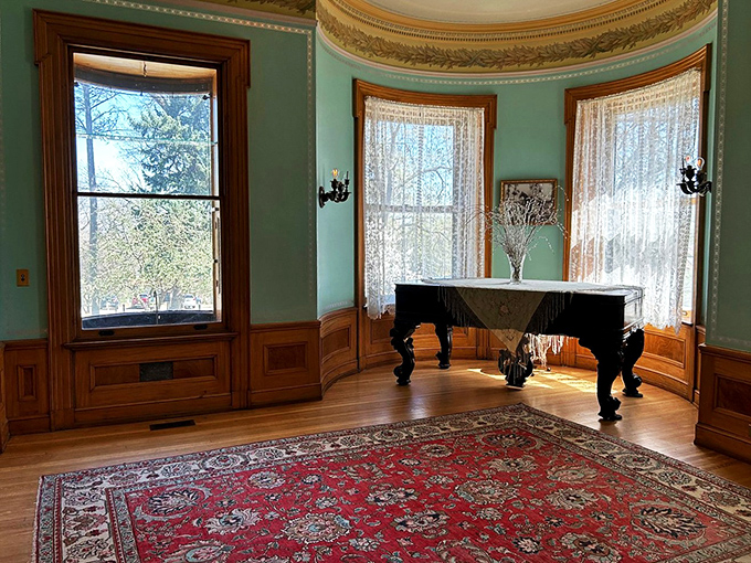 The music room's bay windows flood the space with natural light, creating the perfect setting for a grand piano that's seen more talented fingers than a hand model convention.
