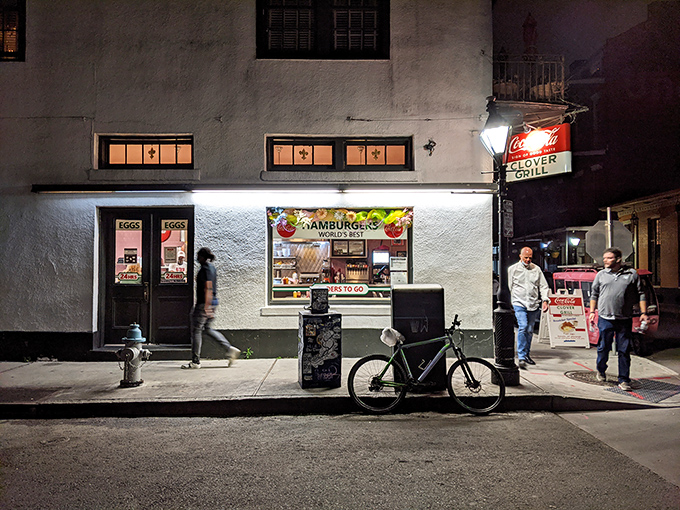 The Clover Grill glows like a midnight beacon for French Quarter wanderers seeking redemption in the form of perfect hash browns.