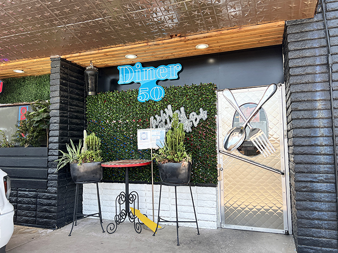 Diner 50's modern facade hides old-school flavor. That plant wall and blue neon sign whisper, "Come in, the pancakes are calling."