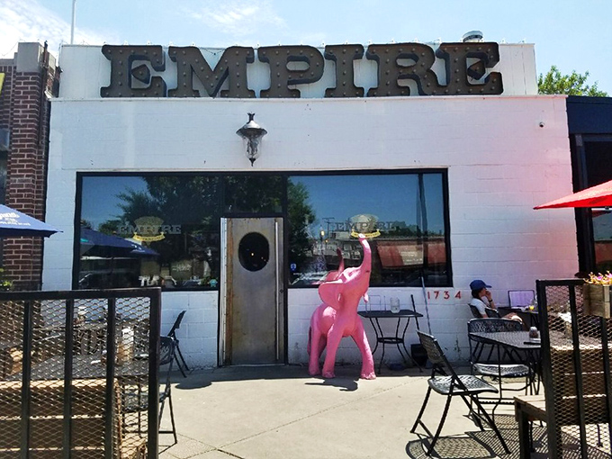 Empire's bold white facade and cheeky pink elephant hint at the pizza rebellion happening inside.