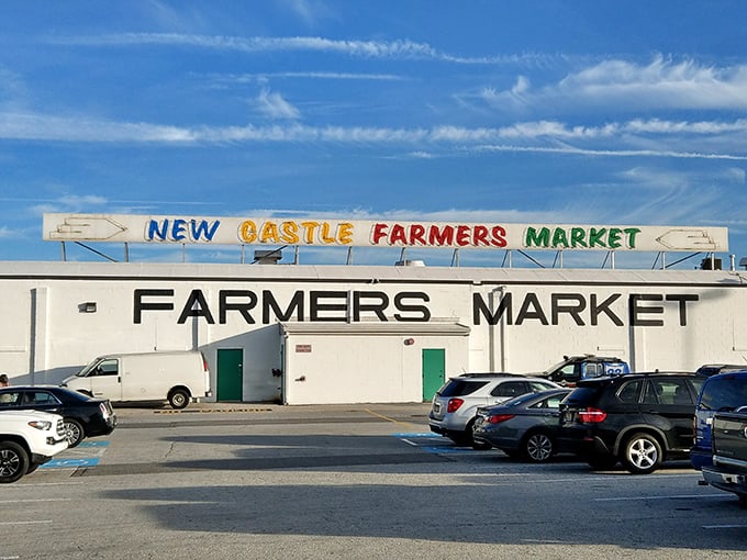 The iconic New Castle Farmers Market sign promises more than just produce - it's a gateway to a world of international treasures.