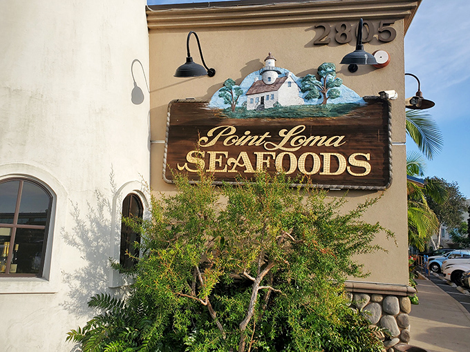 Point Loma Seafoods' hand-painted sign promises maritime treasures inside this coastal gem. The lighthouse-inspired building delivers on that promise!