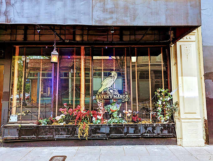 Raven's Manor's enchanting entrance, where floral arches invite you into a world of spooky sophistication.