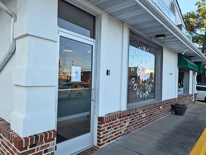 Behind that birdhouse-inspired facade lies a wonderland of artisanal donuts that would make Homer Simpson weep with joy.