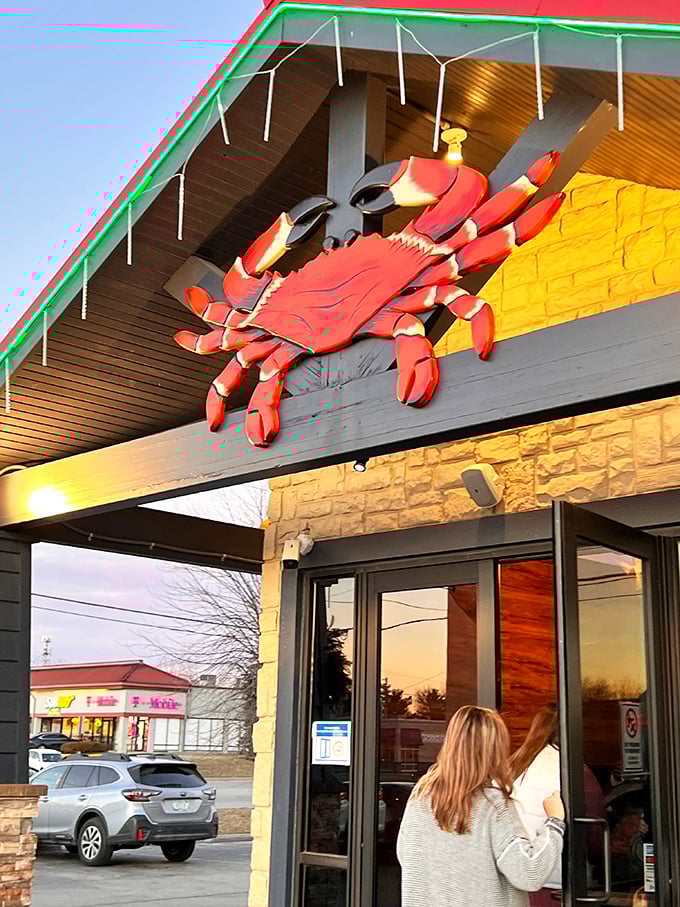 The giant crab perched above Juicy Seafood warns diners: messy hands and happy faces ahead. 