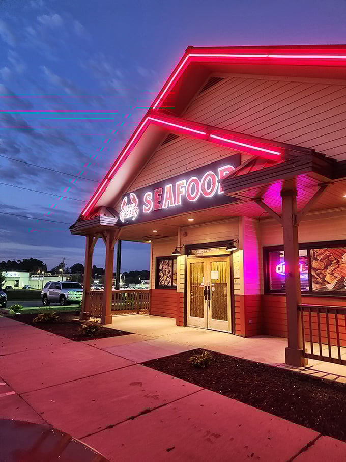 Yummy Crab's neon glow against twilight sky - like a Vegas casino, but the only gambling is how many crab legs you can finish.