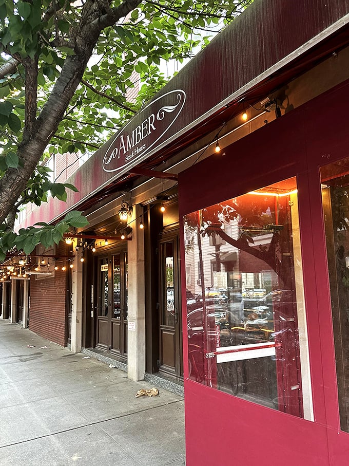 Those twinkling lights and rich burgundy tones at Amber hint at what's to come: an evening of old-world steakhouse magic.