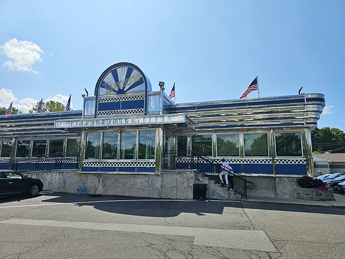 American flags flutter above Blue Colony Diner's polished exterior &ndash; a shining temple to the religion of comfort food. 
