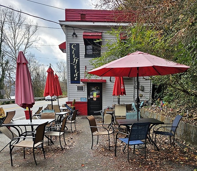Red umbrellas at Cliffside Diner offer shade for recovery after their massive breakfast portions. The outdoor seating is where food comas go to happen!