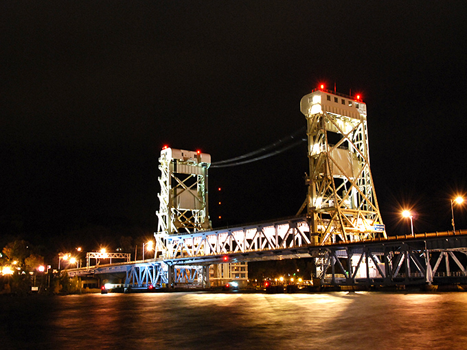 Nighttime transforms Houghton's lift bridge into a glowing sculpture against the Upper Peninsula's star-filled sky.