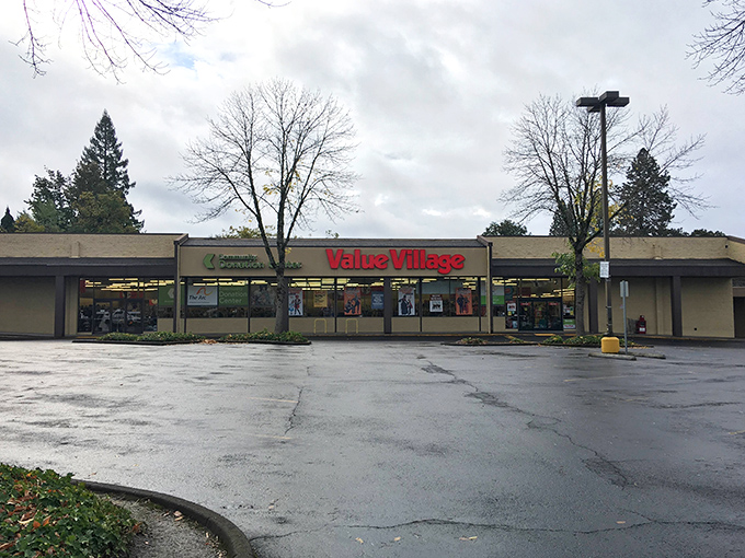 Morning light illuminates Value Village's familiar red signage, a beacon for early birds seeking the freshest secondhand worms. 