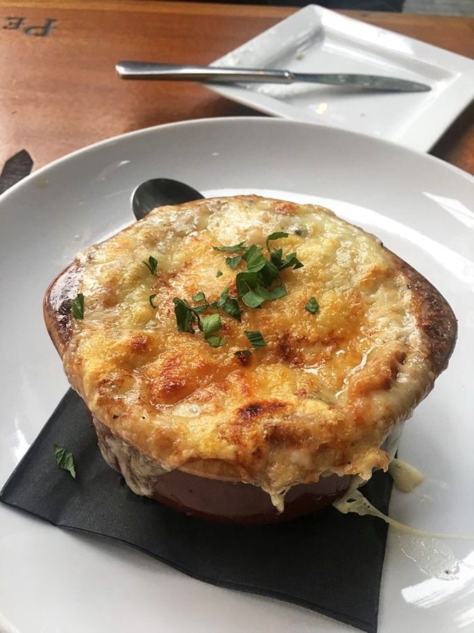 The holy trinity of soup perfection: deeply caramelized onions, rich beef broth, and a crown of melted cheese that stretches for days. 