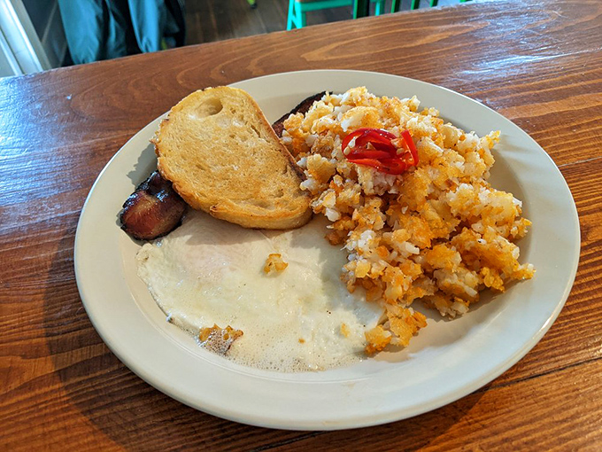 The classic American breakfast, reimagined with crispy hash browns that deserve their own fan club. That sunny-side egg is basically winking at you.