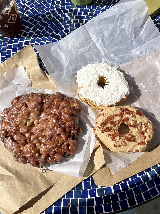 The holy trinity of breakfast indulgence: one magnificent apple fritter alongside its distinguished coconut and maple bacon companions. Decisions, decisions.