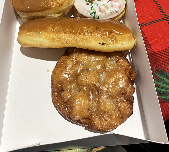 The ultimate to-go box: glazed perfection, sprinkled joy, and the apple fritter that locals drive across town for—all waiting to make your day infinitely better.