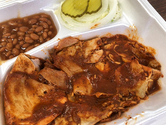 This to-go container holds the kind of barbecue that makes you pull over before leaving the parking lot. Patience has never been so challenged.