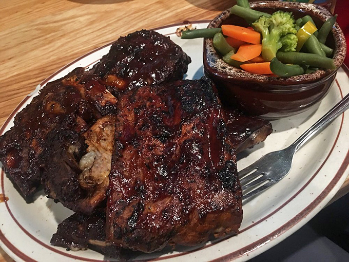 Behold the perfect marriage of smoke, meat, and time. These ribs sport that coveted pink smoke ring that barbecue aficionados chase like treasure hunters.