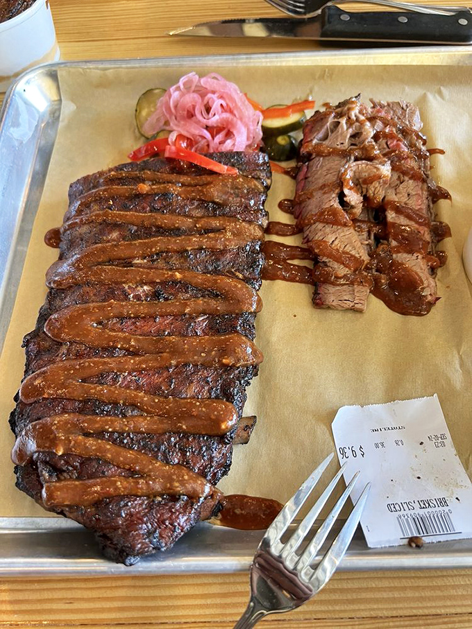 Ribs and brisket drizzled with sauce like a Jackson Pollock of protein. This isn't just dinner; it's edible art.