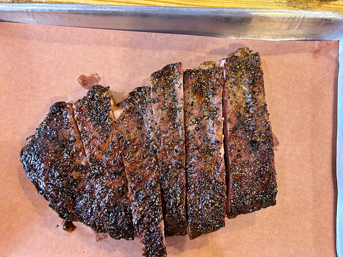 Brisket sliced against the grain reveals that telltale pink smoke ring, while the baked beans look like they've been simmering since yesterday morning.