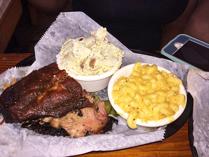 When your plate arrives with that bark-crusted brisket nestled against mac and cheese, life suddenly makes perfect sense.