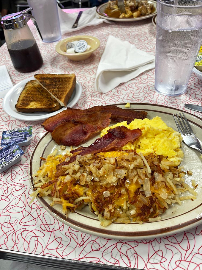 This isn't just breakfast; it's edible nostalgia. Crispy bacon, sunny eggs, and those legendary hash browns form the holy trinity of morning perfection. 