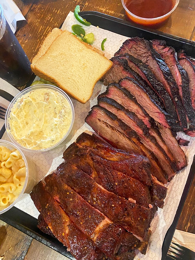 The Texas two-step: brisket and ribs sharing a dance floor of butcher paper. This isn't just dinner &ndash; it's a religious experience with pickles and bread.