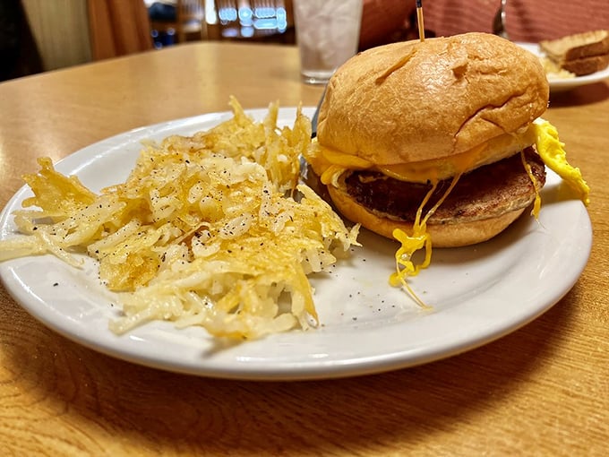Behold the breakfast sandwich in its natural habitat&mdash;a golden brioche bun cradling eggs and cheese with hash browns standing guard nearby.