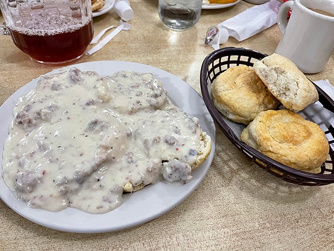 Biscuits so fluffy they should need their own ZIP code, with gravy that's basically a sausage-studded security blanket for your taste buds.