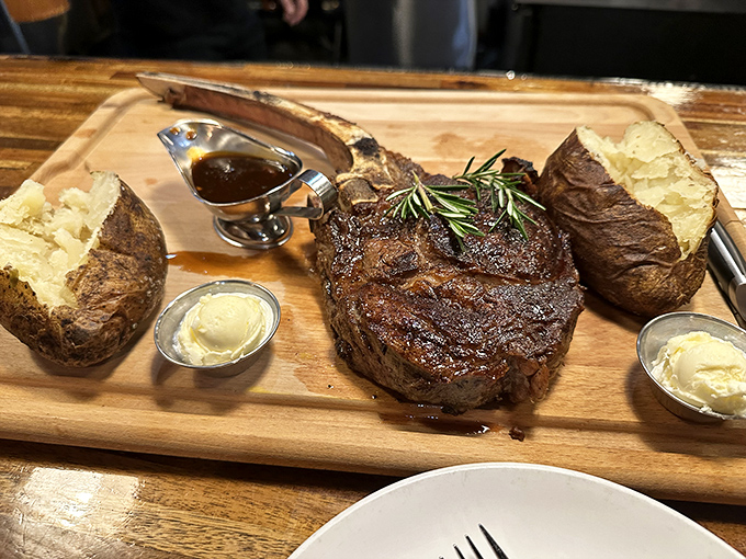 The wooden board presentation isn't just for show&mdash;it's a ceremonial altar for worshipping perfectly cooked beef. Those baked potatoes are wearing butter like formal attire.