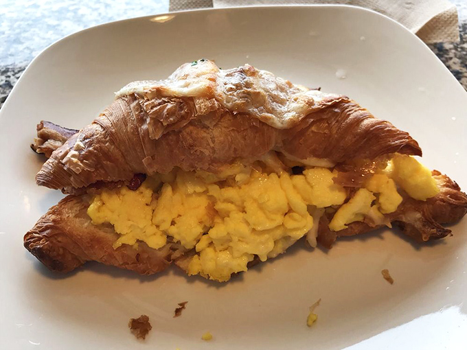 Breakfast nirvana exists, and it looks exactly like this: a perfectly laminated croissant stuffed with fluffy scrambled eggs. Morning commutes just found their purpose.