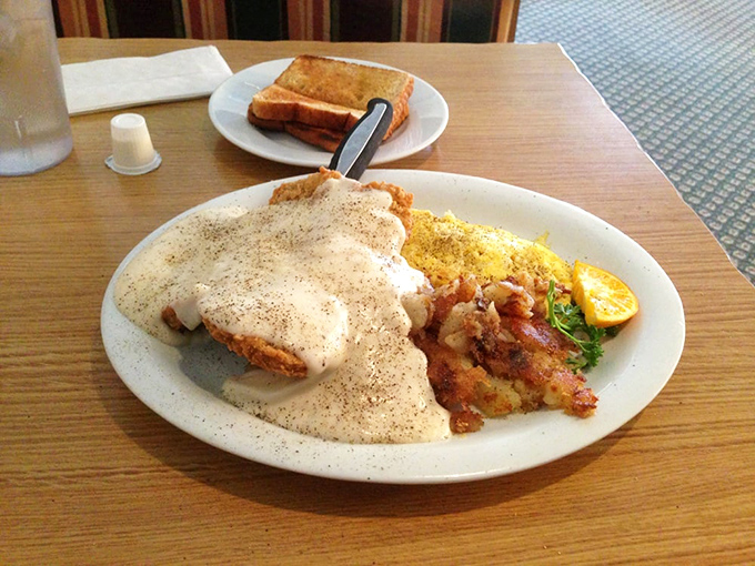 Breakfast nirvana: golden fried chicken smothered in peppery gravy alongside scrambled eggs. The kind of plate that makes you consider breakfast for every meal of the day.