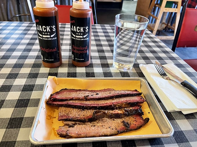 Slices of brisket with Jack's signature sauces standing by &ndash; though meat this good barely needs embellishment.