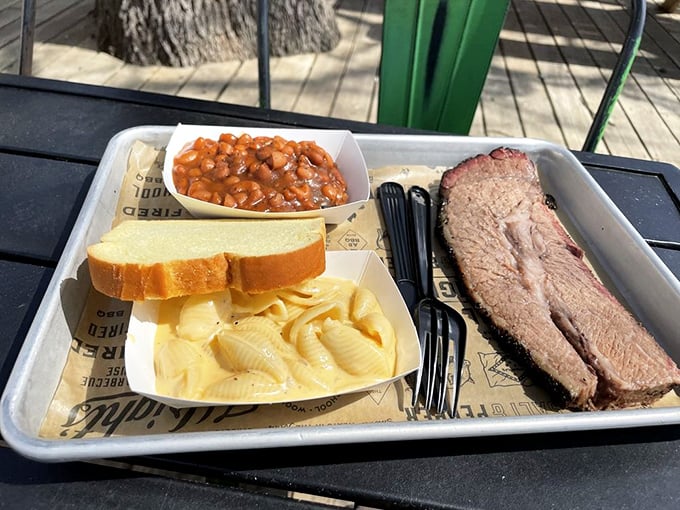 Simplicity at its finest: slices of brisket with that telltale pink smoke ring, mac and cheese, and beans that mean business.