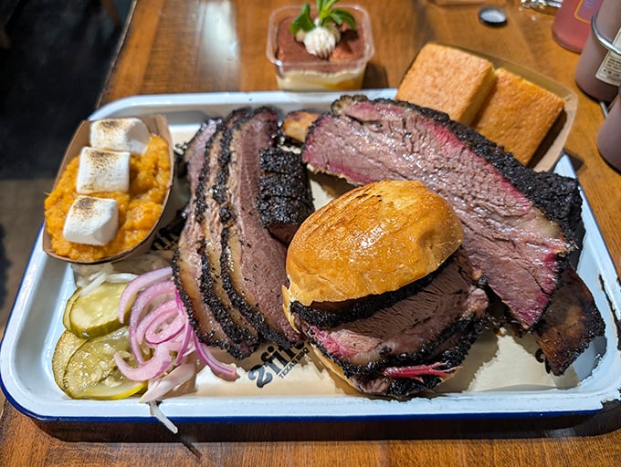 Behold the Texas trinity: perfectly pink-ringed brisket, glistening ribs, and a sandwich that makes you question why you'd ever eat anything else.