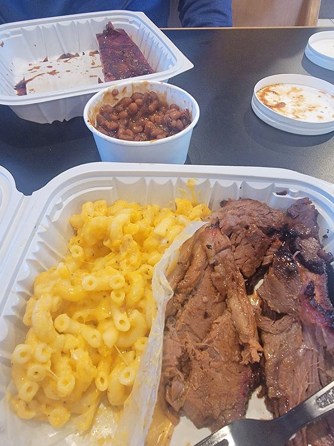 The holy trinity of barbecue perfection: brisket with a bark that could make a tree jealous, mac and cheese, and beans that didn't come from any can.