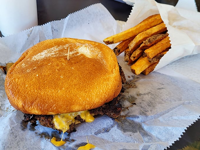 The perfect burger-to-bun ratio is no accident. That melty cheese cascading down the patty is performing a delicious gravity experiment.