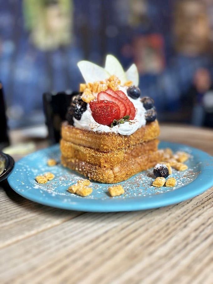 The Captain Crunch French Toast arrives like breakfast royalty&mdash;crowned with berries, cream, and cereal crunch that transforms childhood nostalgia into grown-up indulgence.