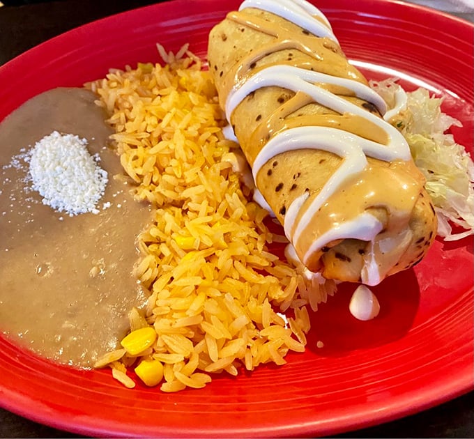 A chimichanga done right doesn't need fancy plating – just a perfect balance of crispy exterior, savory filling, and that drizzle of crema.