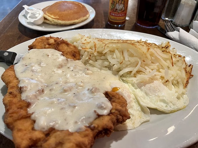 Breakfast of champions: crispy-edged chicken fried steak meets perfectly crisped hash browns and sunny-side-up eggs &ndash; the holy trinity of morning indulgence.