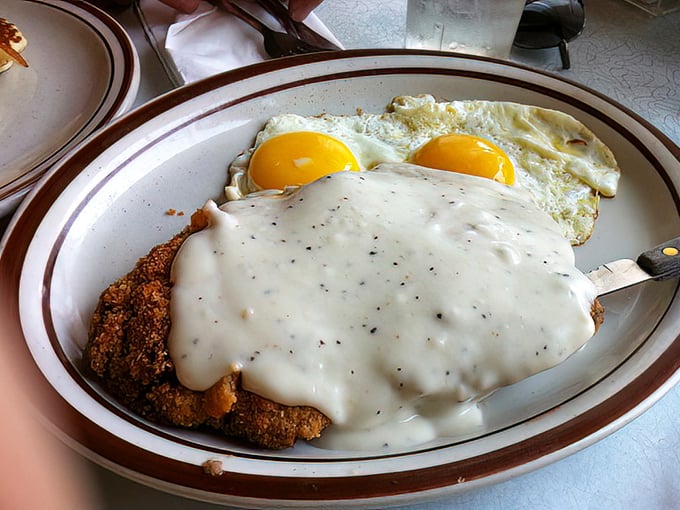The holy trinity of diner perfection: golden-crisp chicken fried steak, farm-fresh eggs, and gravy that could make a vegetarian question their life choices.
