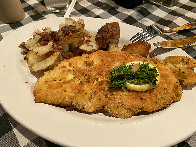 The schnitzel whispers "perfection" with each golden-brown bite, while the potato salad delivers that bacon-infused tanginess Germans have perfected over centuries.