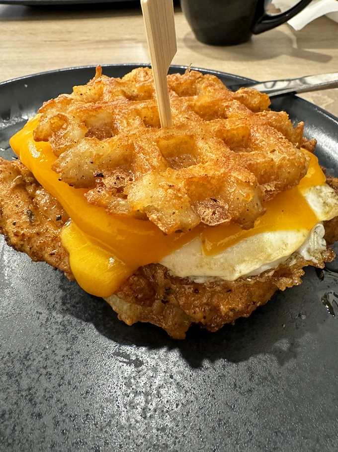 The breakfast sandwich reimagined&mdash;crispy hash brown waffles embracing eggs and cheese like long-lost friends at a delicious reunion.