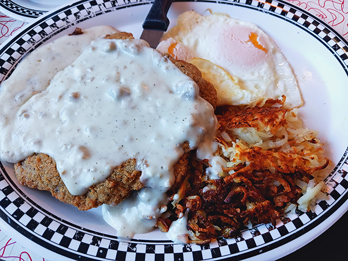 The star of the show: chicken fried steak wearing its gravy like a couture dress, paired with perfectly crispy hash browns and eggs sunny enough to brighten your day.