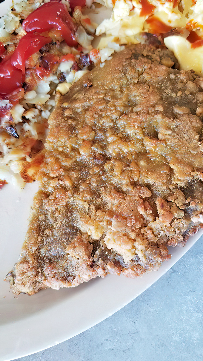 Golden-crisp exterior giving way to tender meat within&mdash;this chicken fried steak isn't just food, it's edible architecture with a PhD in comfort.