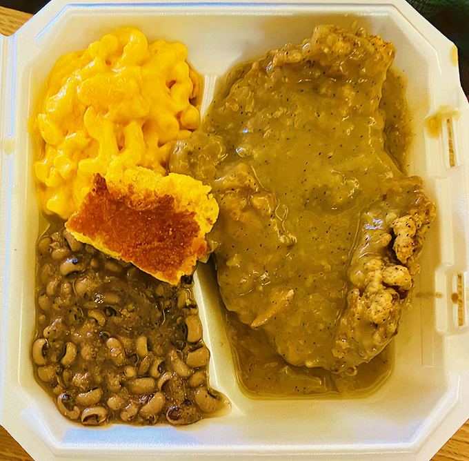 A symphony of comfort on a to-go plate: golden-crusted chicken fried steak, mac and cheese, black-eyed peas, and cornbread that would make your grandmother jealous.
