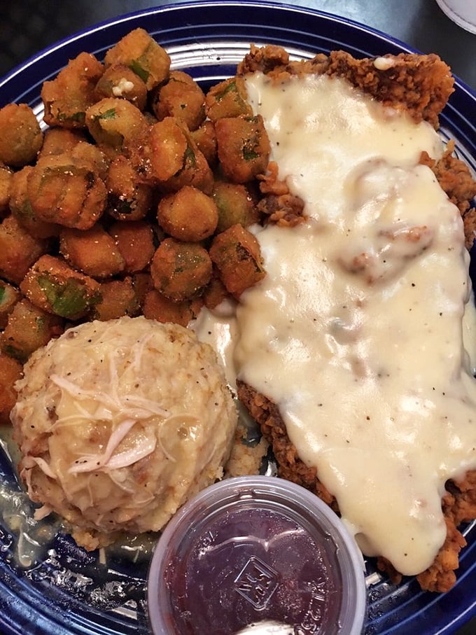 Chicken fried steak so good it should require a license. That golden gravy cascade meets crispy okra in a Southern symphony of crunch.